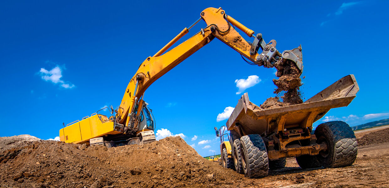 Lubrication of pin-and-bush connections in earthmoving